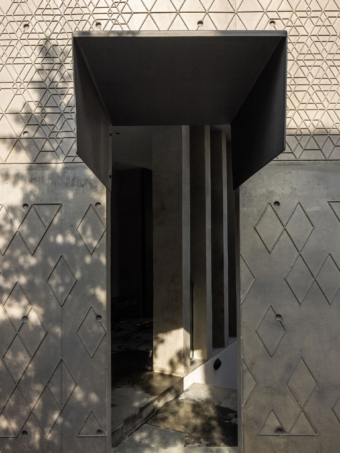 This fortress-like concrete house in Singapore hides a surprise within
