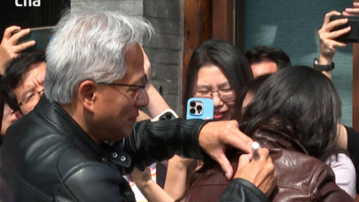Nvidia CEO Jensen Huang signs reporter's jacket - CNA