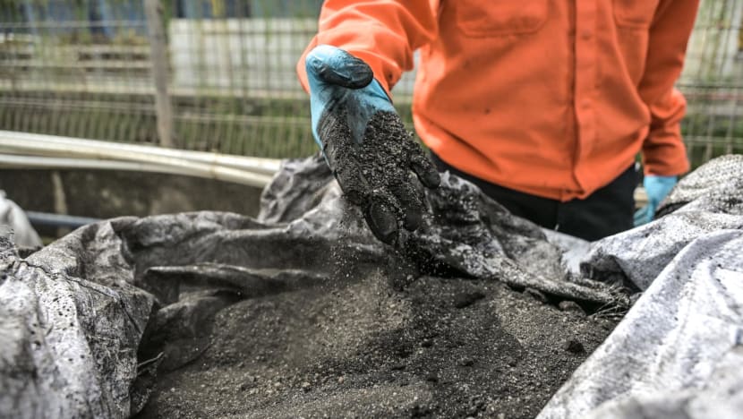 Repairing snapped booms, treating oil-slicked sand: Oil spill clean-up ...