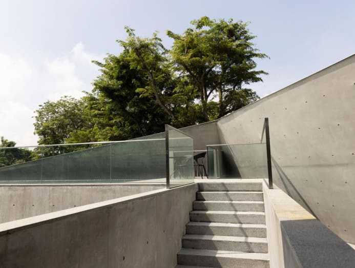 This fortress-like concrete house in Singapore hides a surprise within